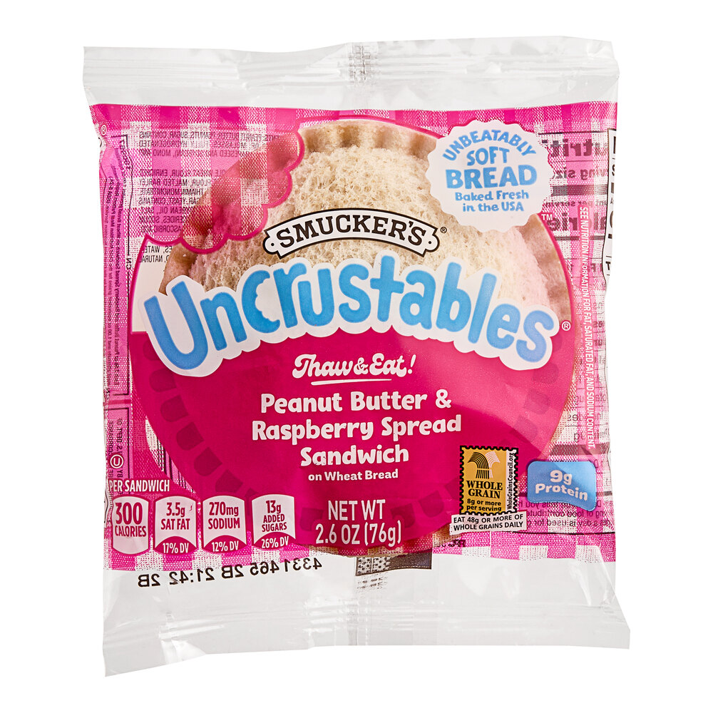 Smucker's Uncrustables Raspberry Spread and Peanut Butter Whole Wheat Sandwich 2.6 oz. - 72/Case