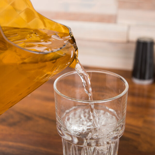 Carlisle 554013 VersaPour 60 oz. Amber Polycarbonate Beverage Pitcher