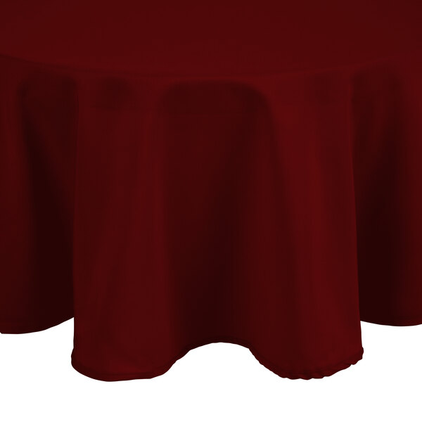 Intedge 120" Round Burgundy Seamed 100% Polyester Hemmed Cloth Table Cover