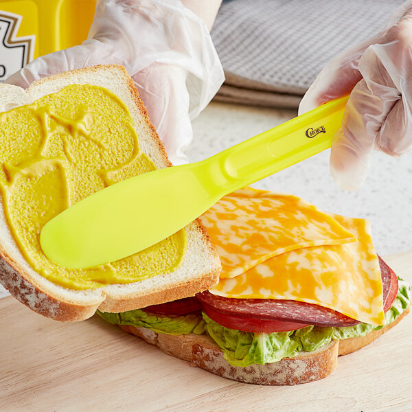 Choice 7 3/4" Smooth Polypropylene Sandwich Spreader with Neon Yellow Handle