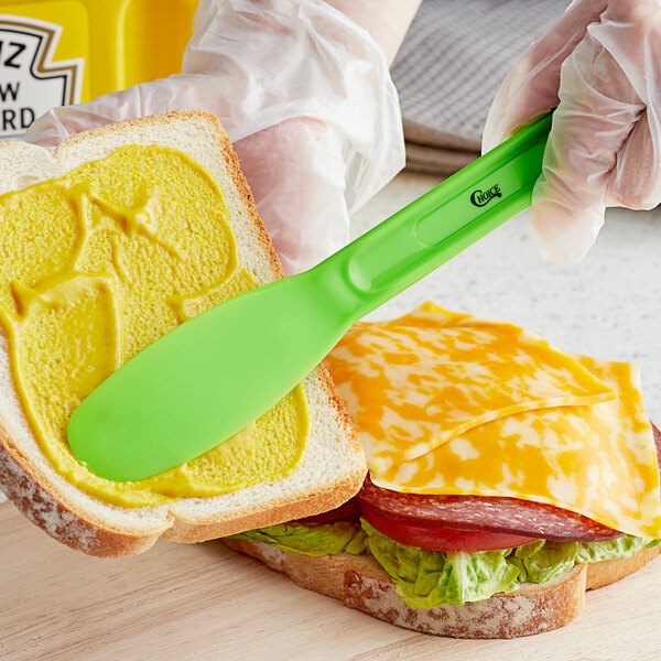 Choice 7 3/4" Smooth Polypropylene Sandwich Spreader with Neon Green Handle