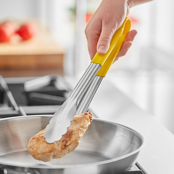 Choice 12" Yellow Coated Handle Stainless Steel Scalloped Tongs