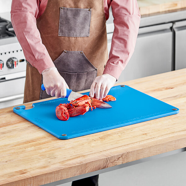 Choice 24" x 18" x 1/2" Blue Cutting Board with Grips, Hook, and Rulers