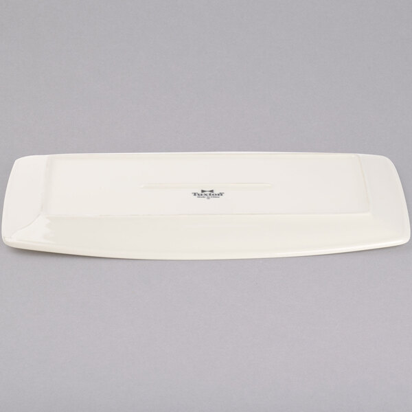 Tuxton BEH-140Q 14" x 8" Eggshell Tapered Rectangular China Plate - 12/Case